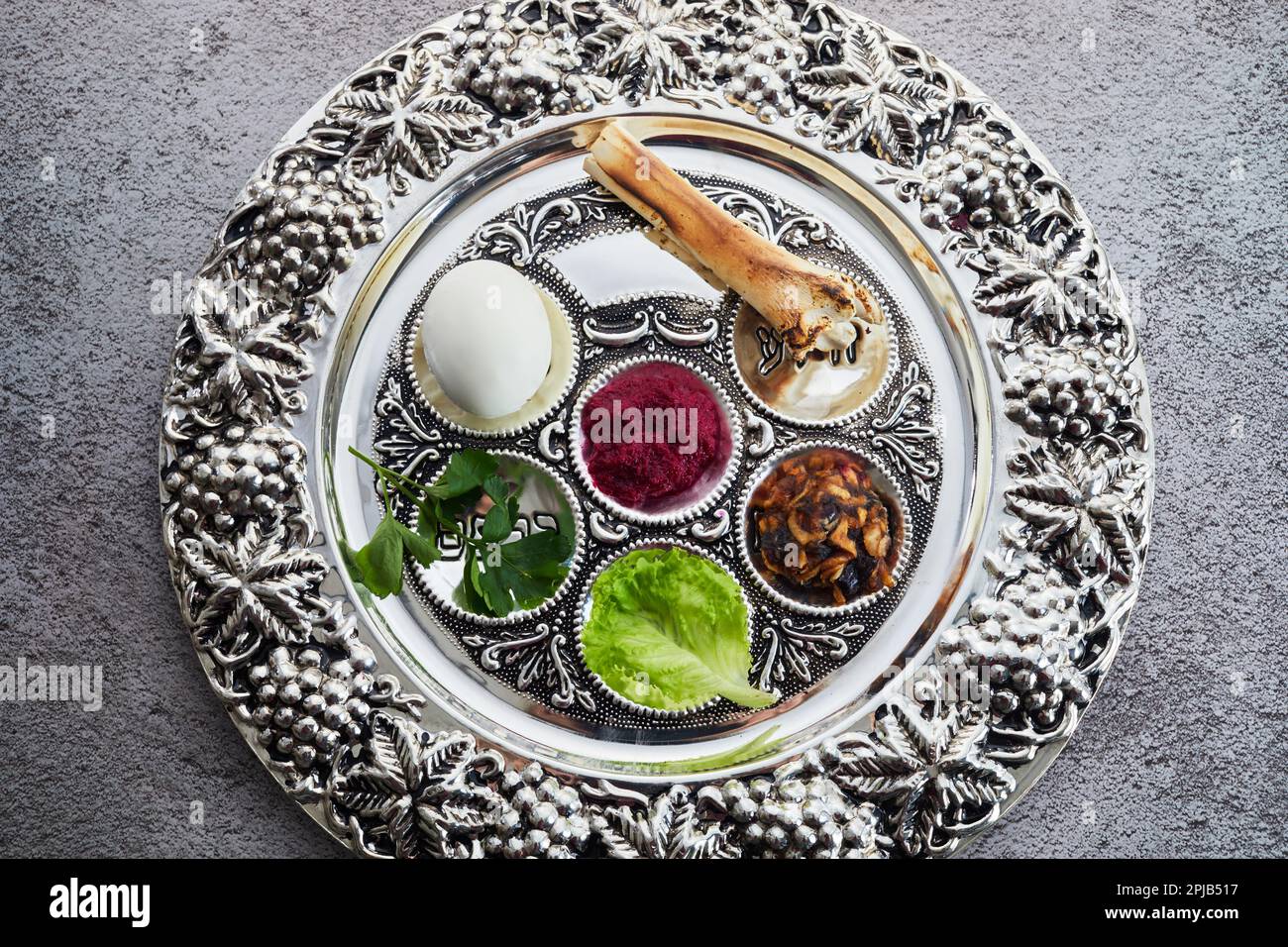 Passover Seder plate with traditional food on grunge background Stock ...