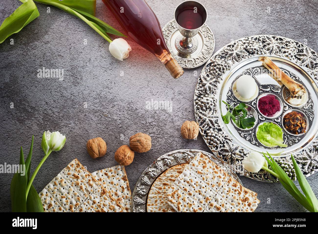 Passover Seder plate with traditional food, walnuts, matza and wine on ...