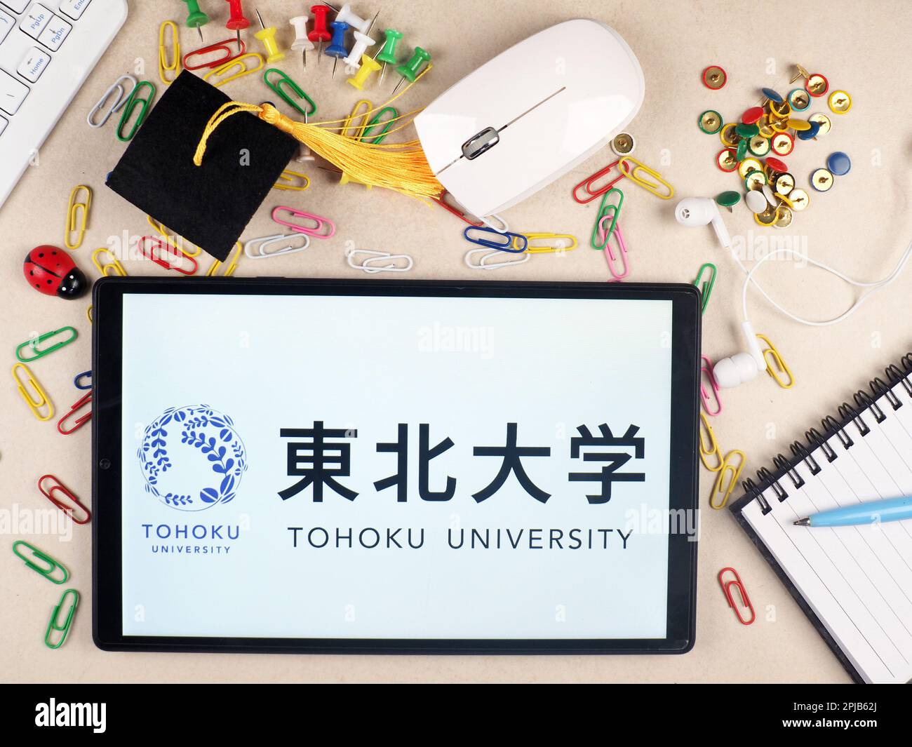 In this photo illustration, a Tohoku University logo seen displayed on ...