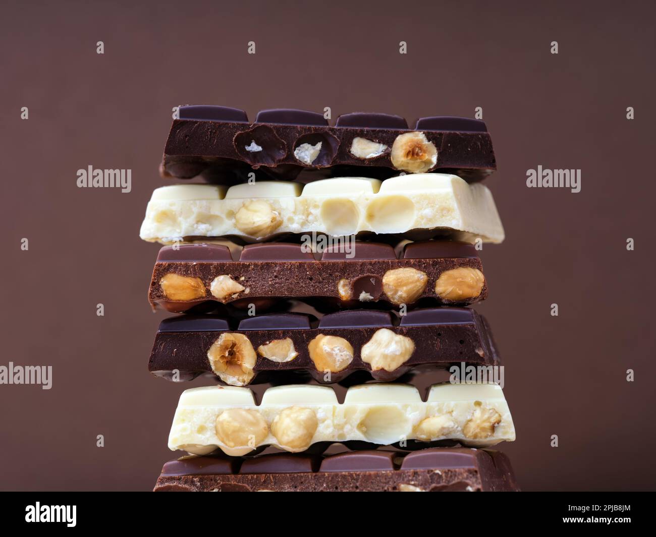 Stack of half chocolate bars with hazelnuts - milk chocolate, dark ...
