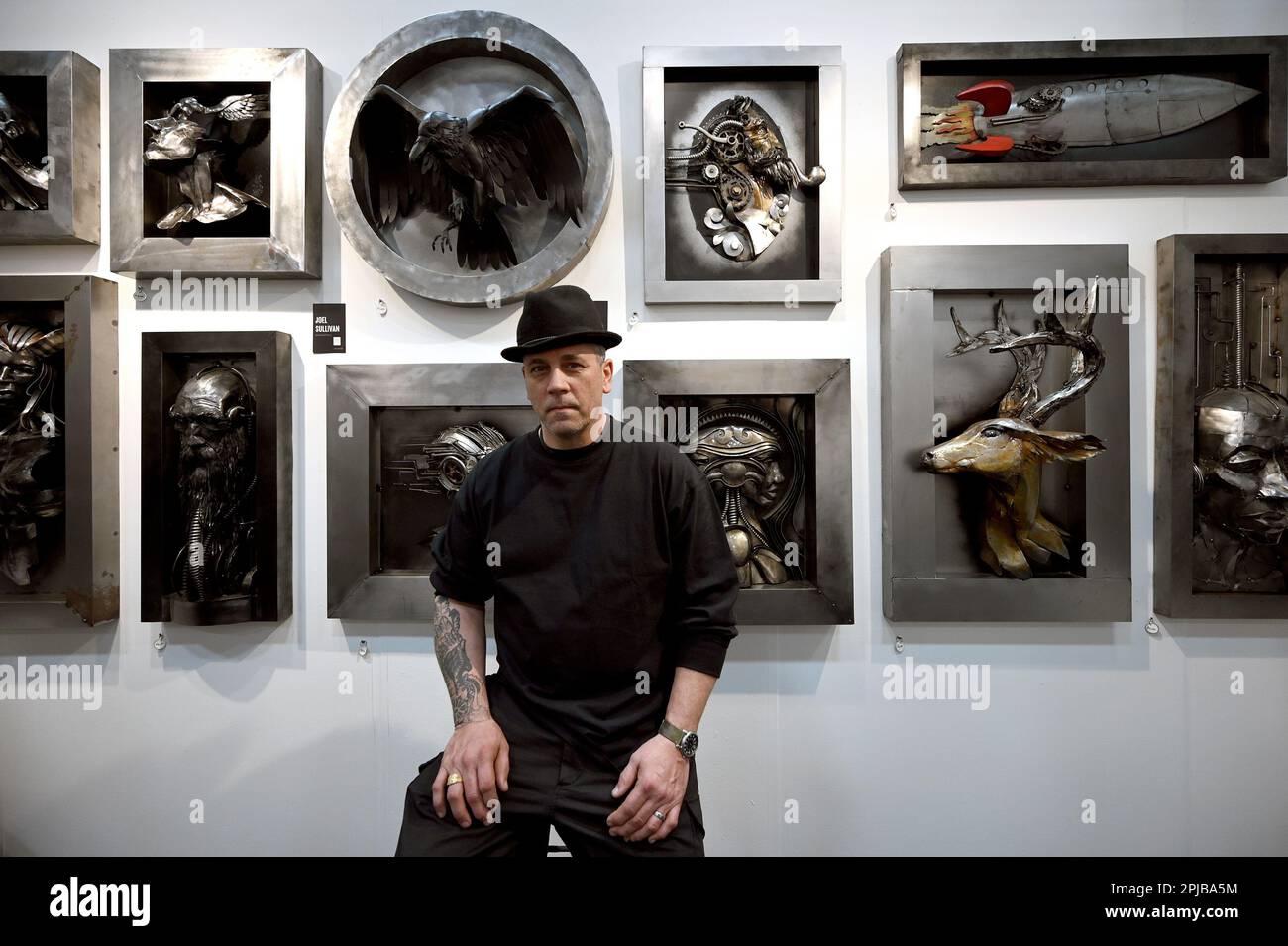 Artist Joel Sullivan poses besides his artwork during the Artexpo New ...