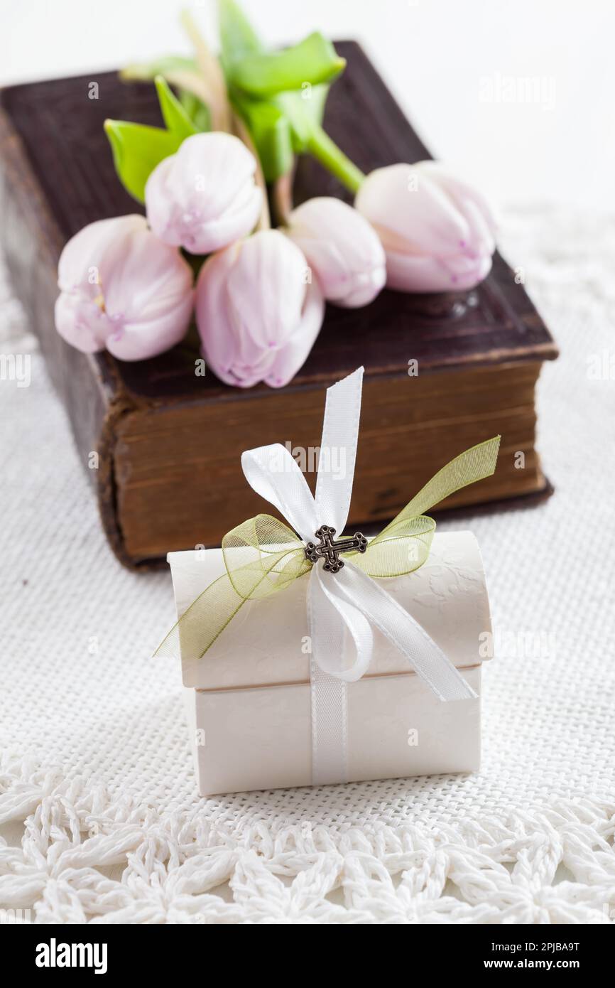 Small present with bible for the first holy communion Stock Photo - Alamy