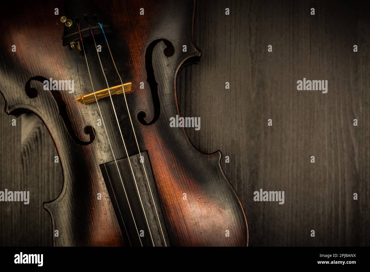 Detail of old violin in vintage style on wood background Stock Photo ...
