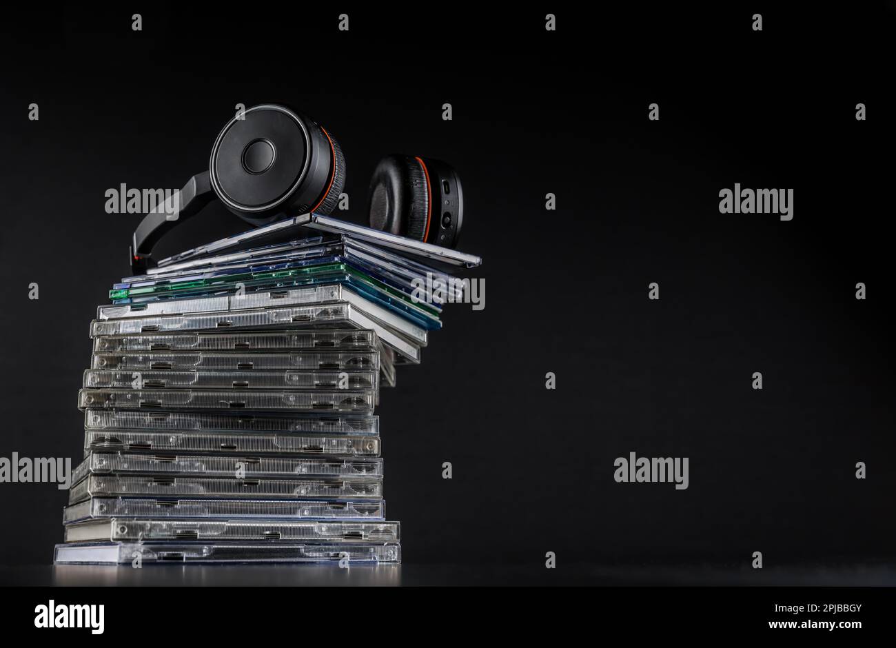 Hi-Fi headphones on stack of CDs on black background with copy space ...