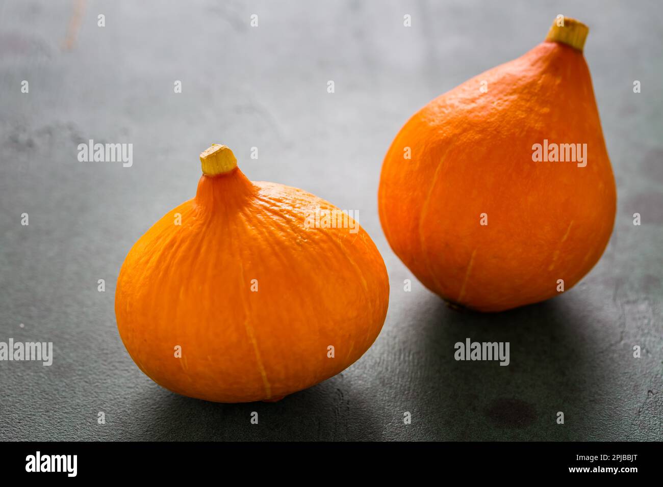 Red kuri squash on green background. Delicious edible pumpkins Stock ...