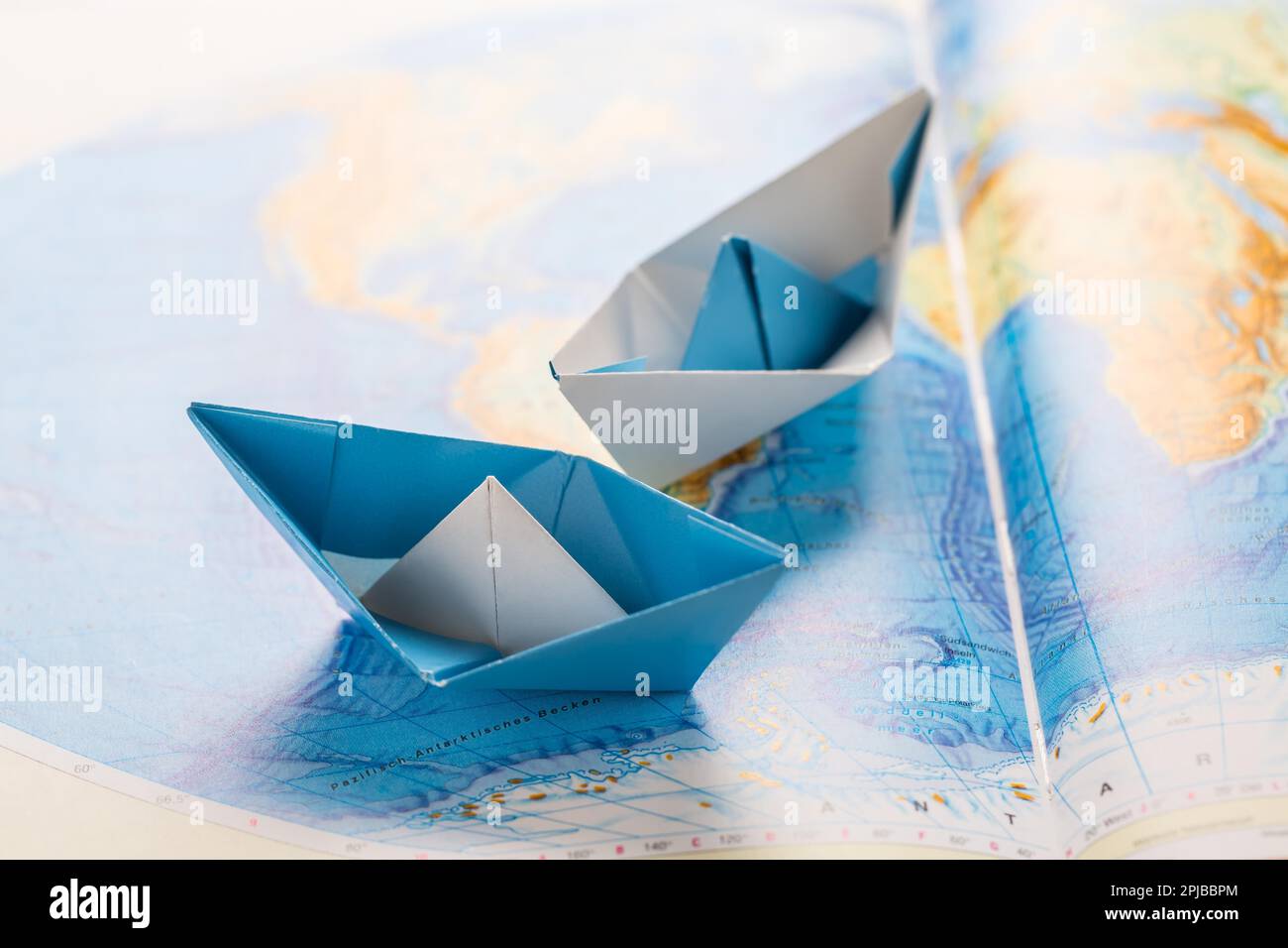 Small paper boats on world map. Concept of traveling or military ...