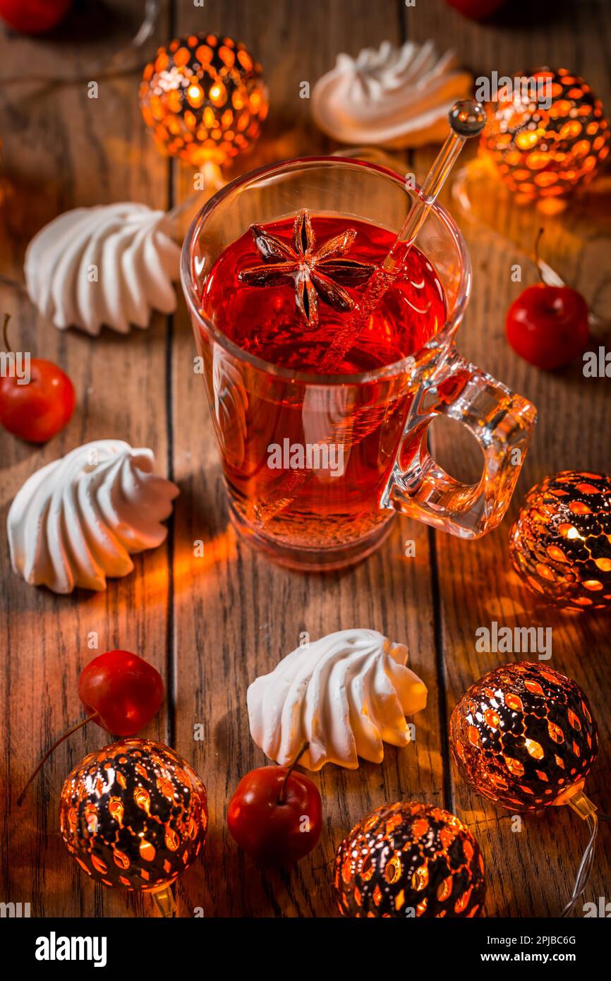 Spicy winter tea or punch with anise and meringue pastry with Christmas ...