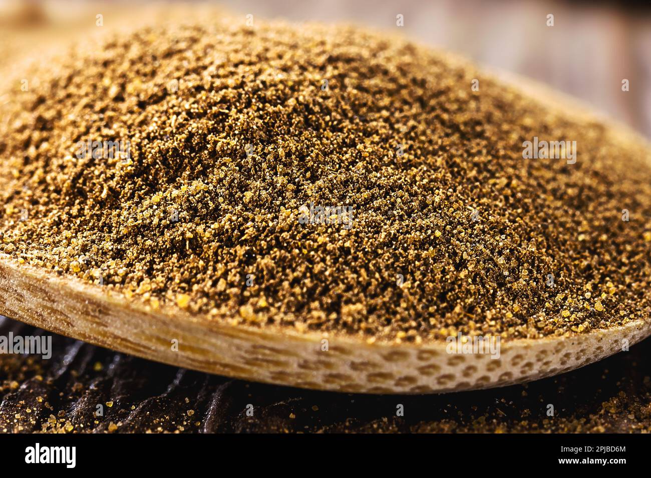spoon of powdered cinnamon, spice obtained from the inner bark of ...