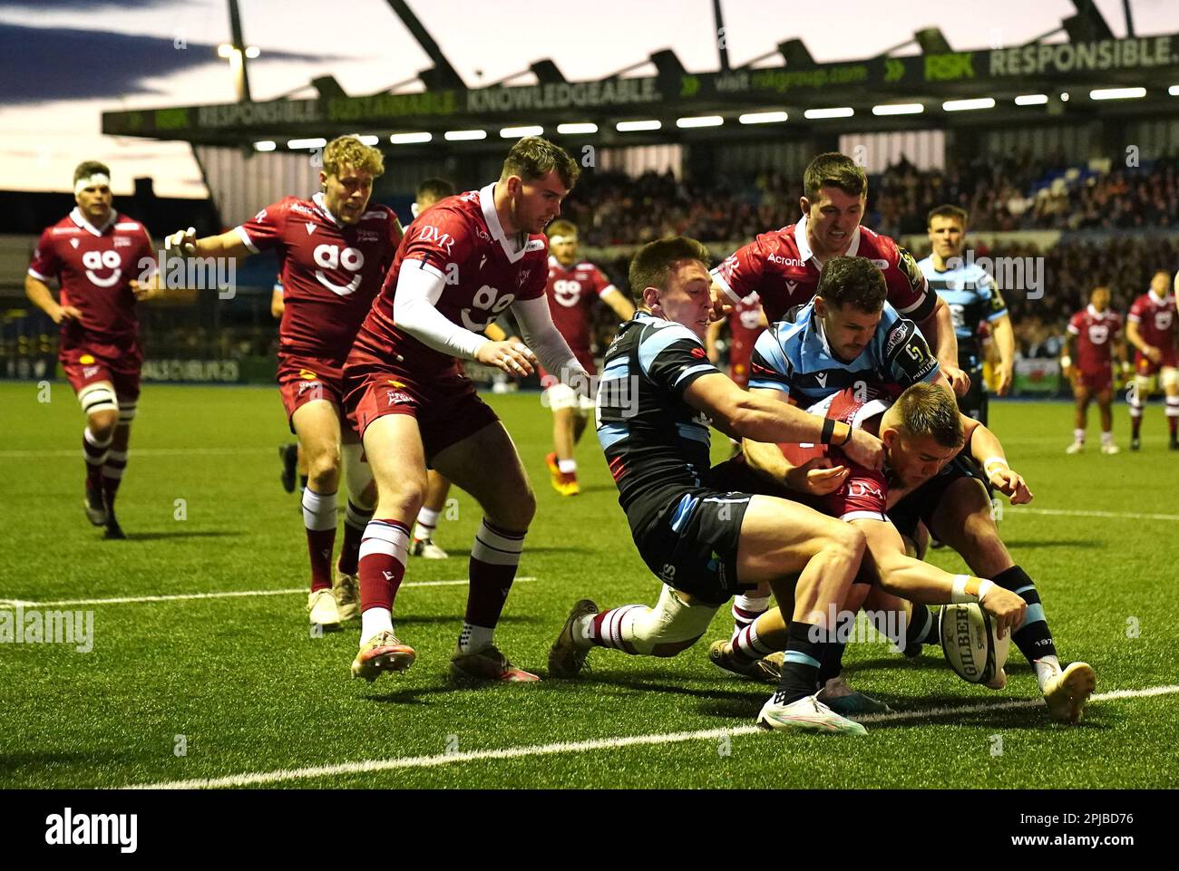 Sale Sharks' Joe Carpenter is held up by Cardiff's Josh Adams and Tomos ...