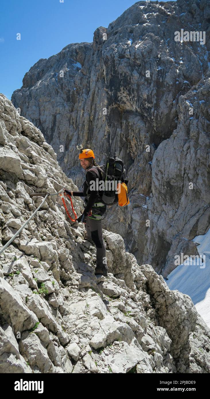 Tourist with equipment on the via ferrata trail in the alps. Zugspitze ...