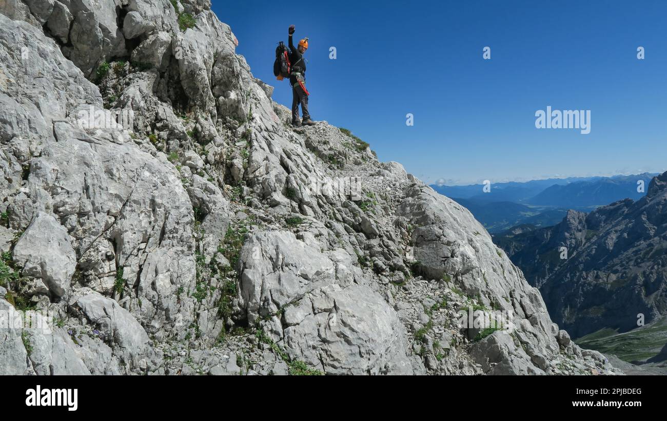 Tourist with equipment on the via ferrata trail in the alps. Zugspitze ...