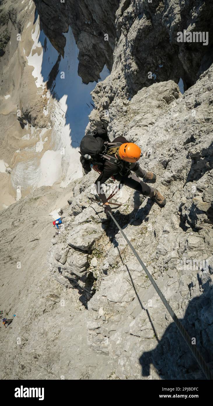 Tourist with equipment on the via ferrata trail in the alps. Zugspitze ...