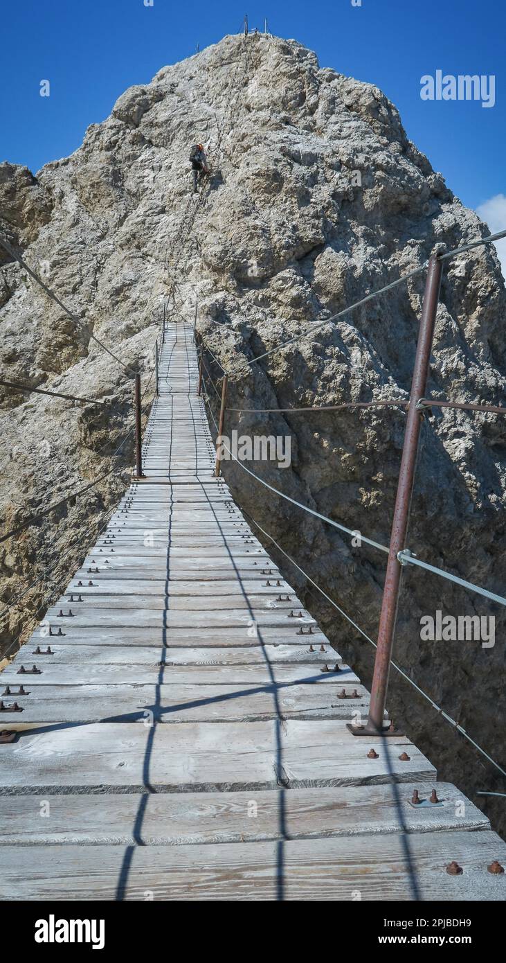 Tourist on the suspension bridge in Monte Cristallo, Dolomite Alps ...