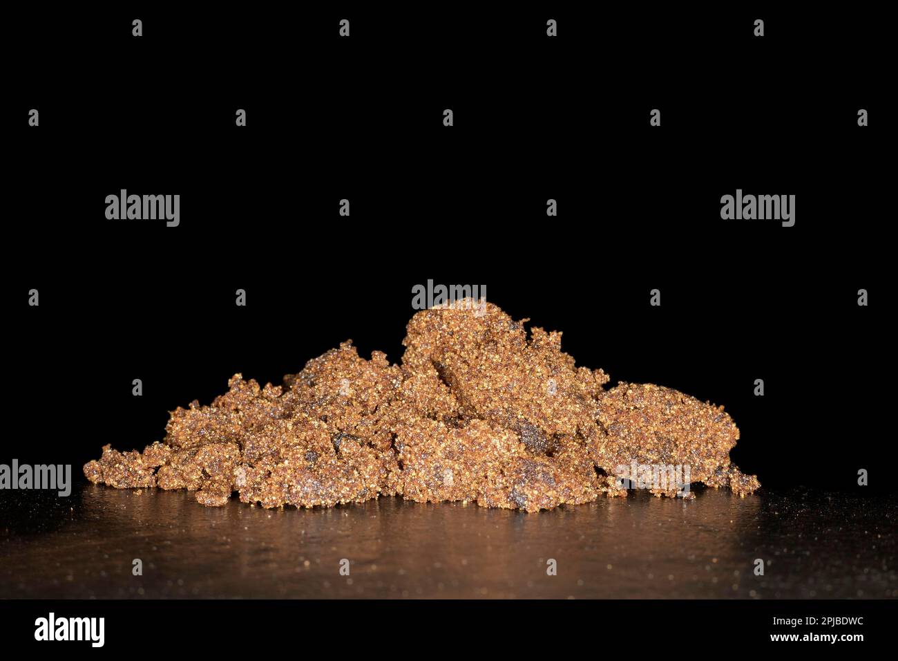 Dark malty muscovado sugar, food photography with black background ...