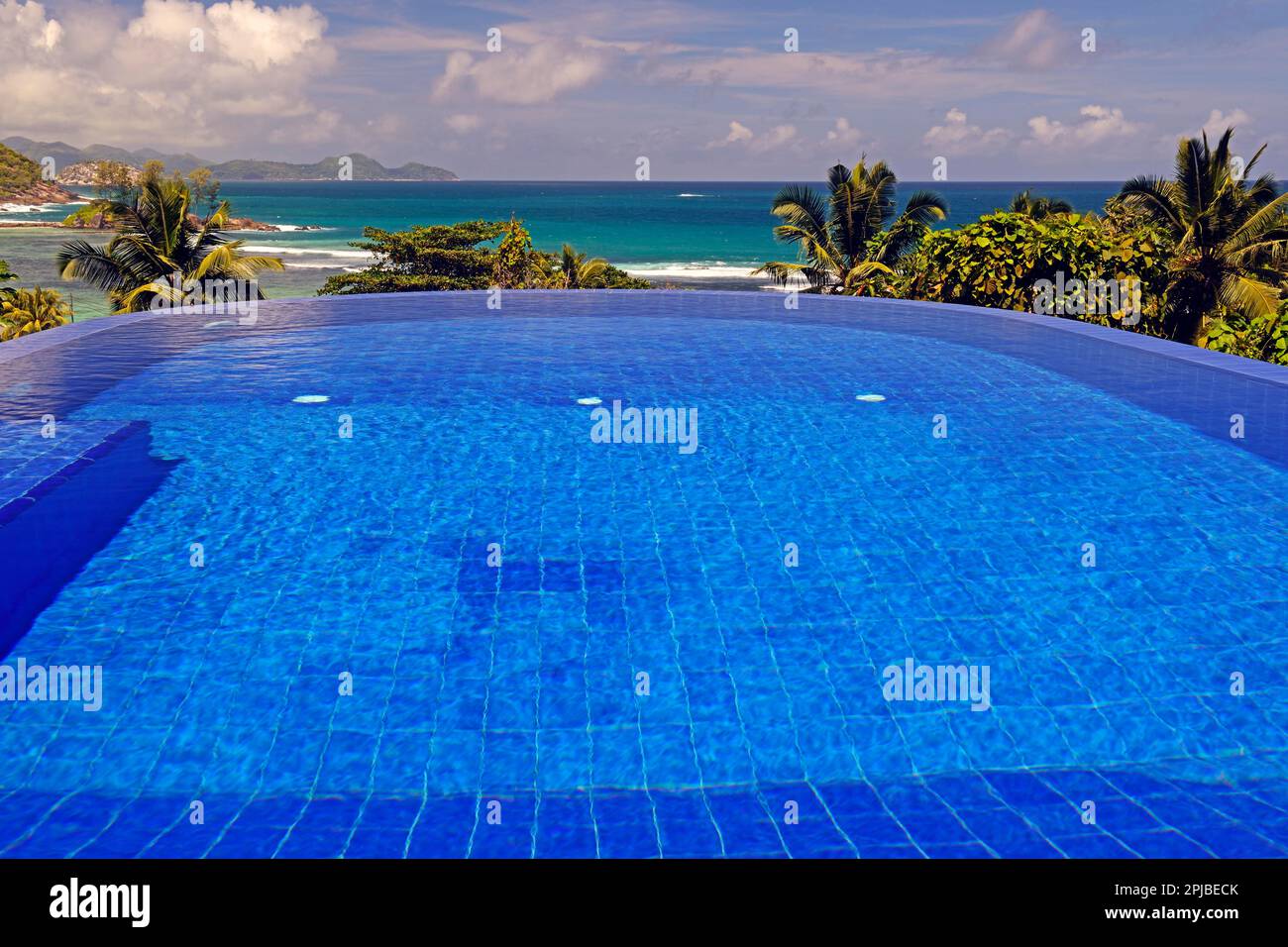 Swimming pool of a luxury villa, view of Indian Ocean at Port Glaud ...