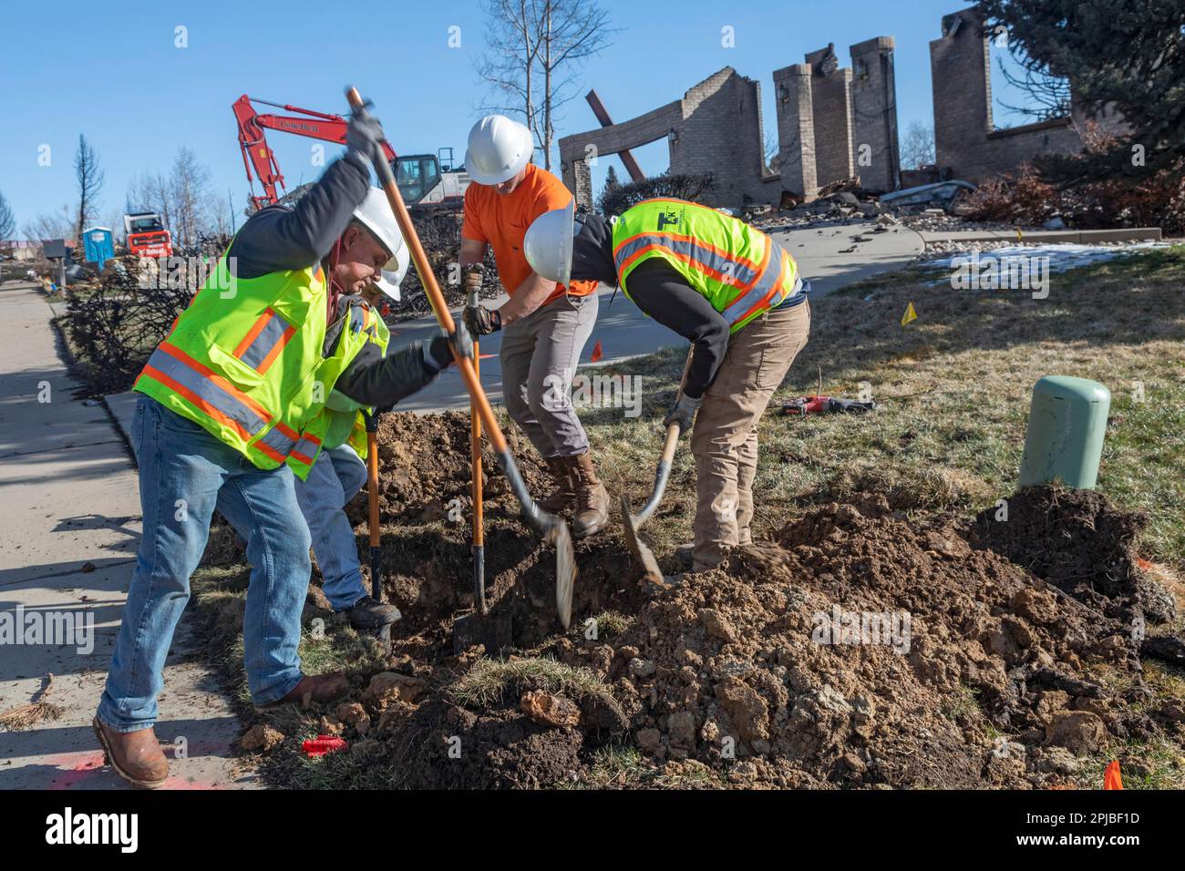 Louisville, Colorado, Workers repair a fiber optic cable after the ...