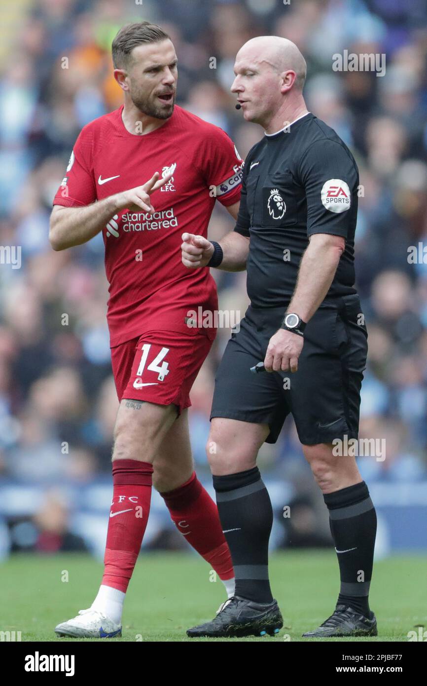 Jordan Henderson #14 of Liverpool talks to referee Simon Hooper during ...