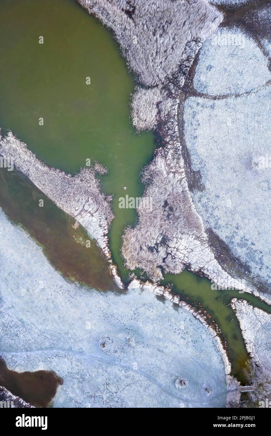 Aerial view, lake landscape, snow, frost, reed area, river course ...
