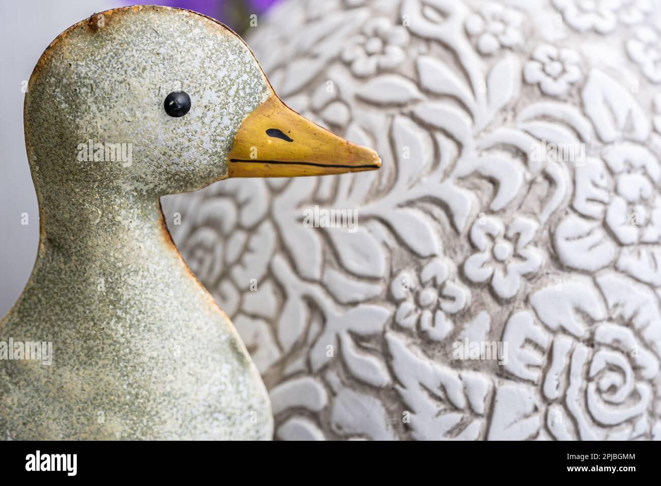 little tin goose with big ornamented egg and lilac spring flowers Stock ...