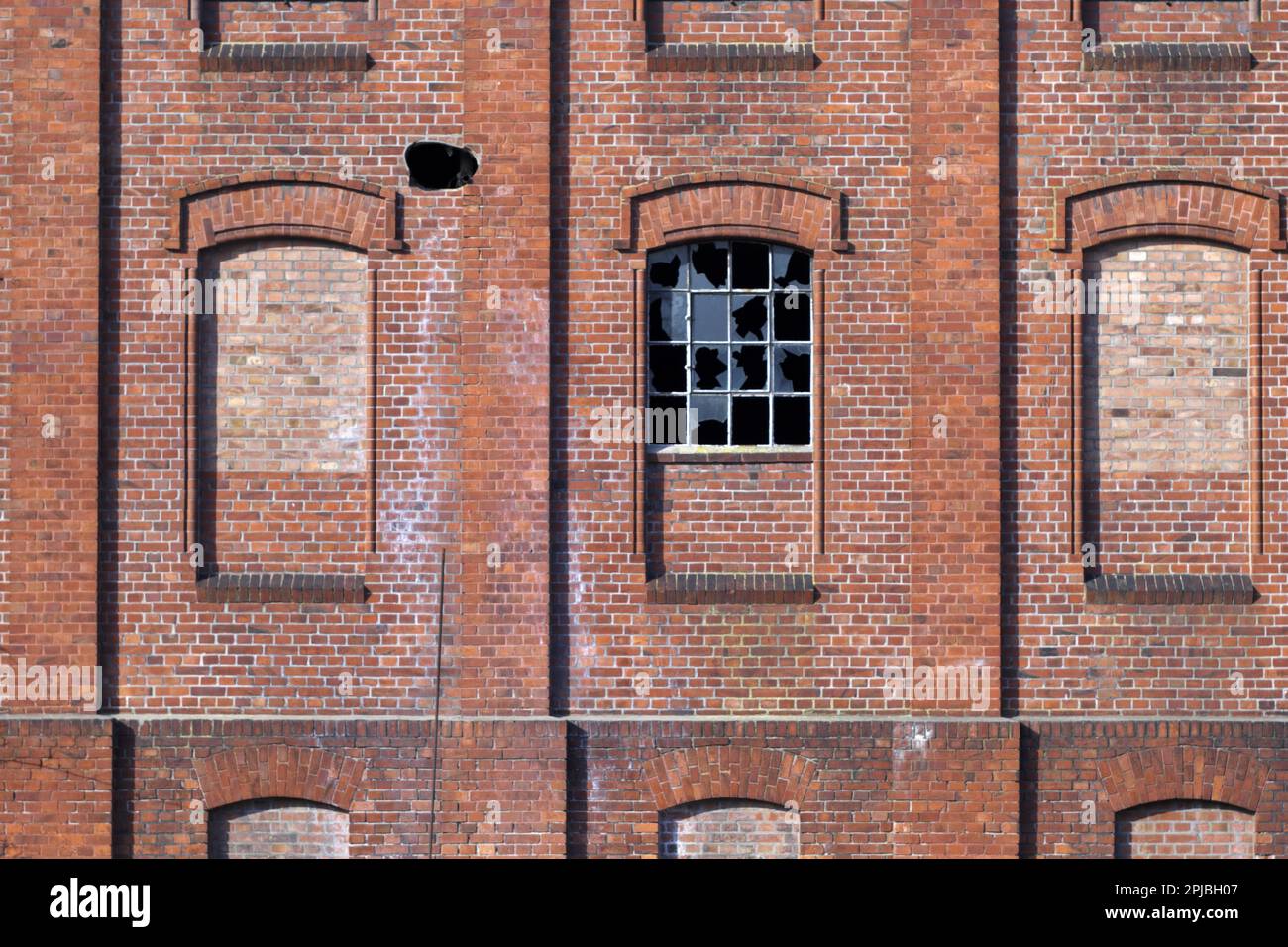 Destroyed window on an old factory building Stock Photo - Alamy