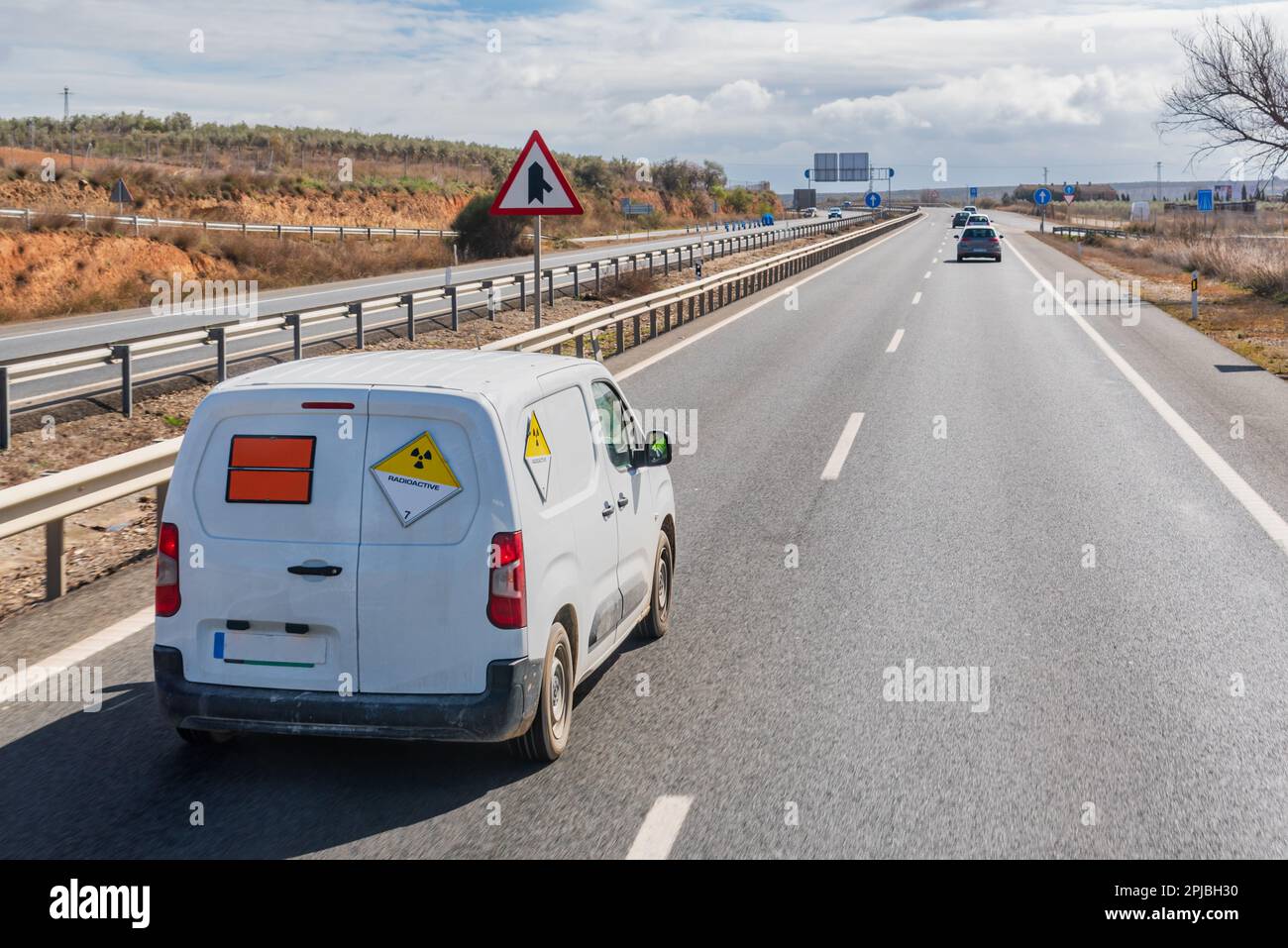 Van with orange plates of dangerous goods and with danger tags by ...