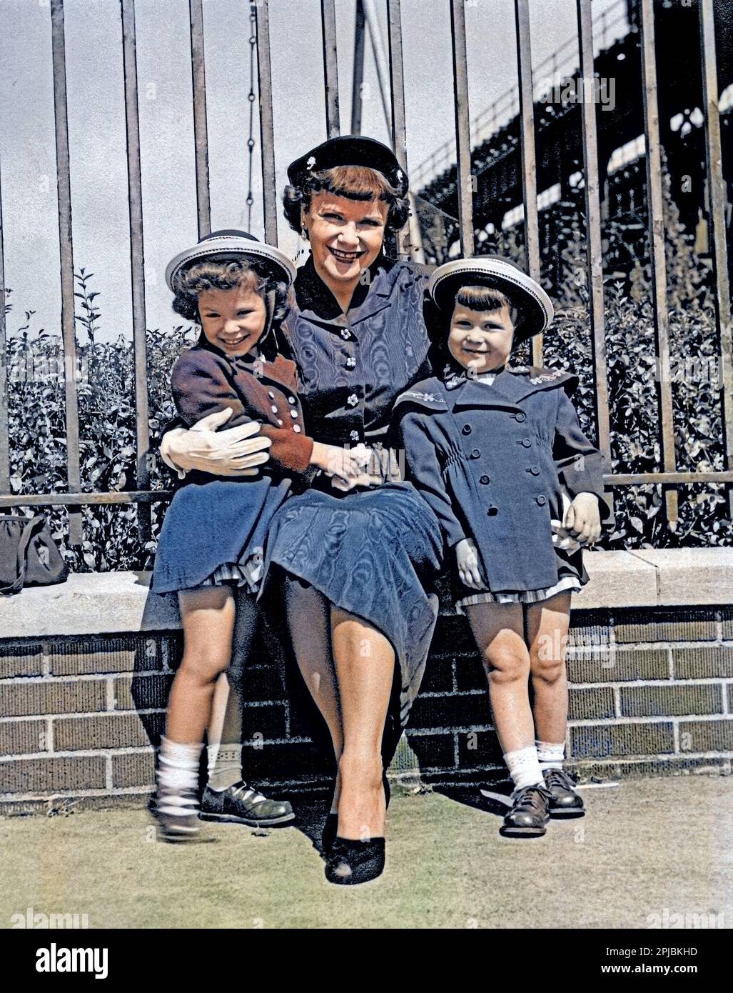 A young mother with her two daughters ages 6 and 8 years old, circa ...