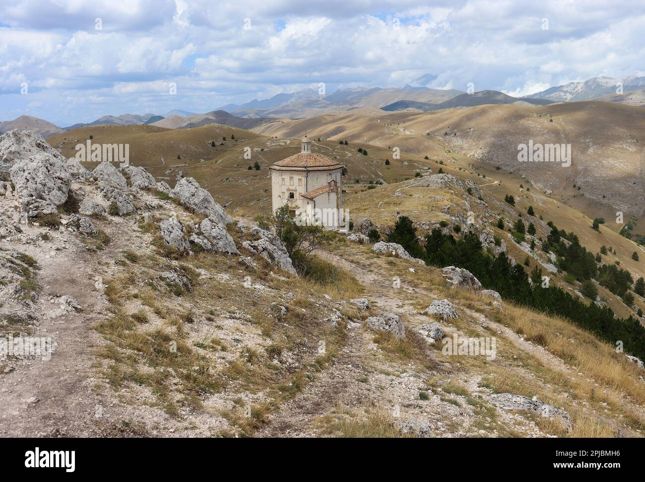 View of a mountain landscape with meadow, trees, steppe and buildings ...