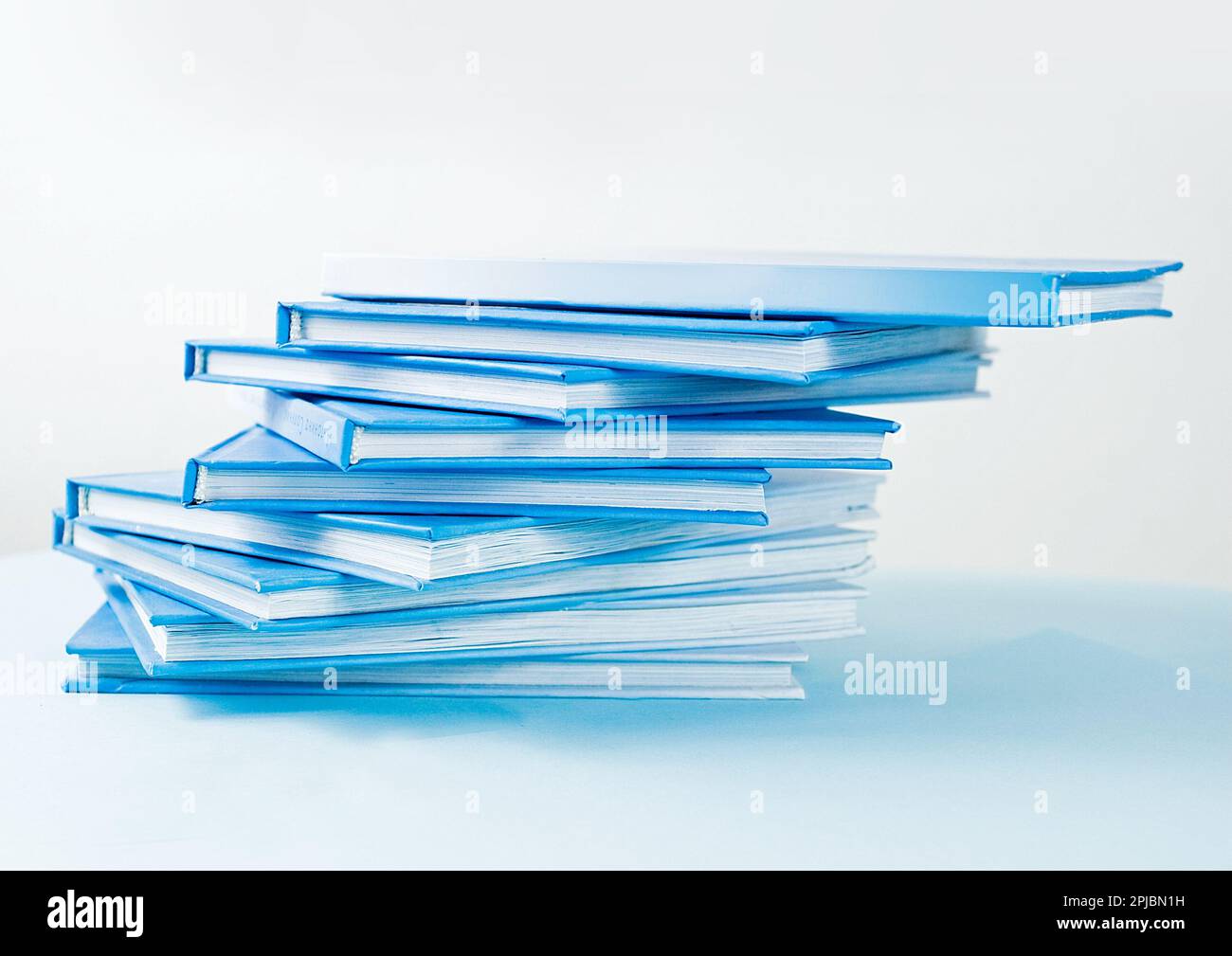 blue books on a white background Stock Photo - Alamy