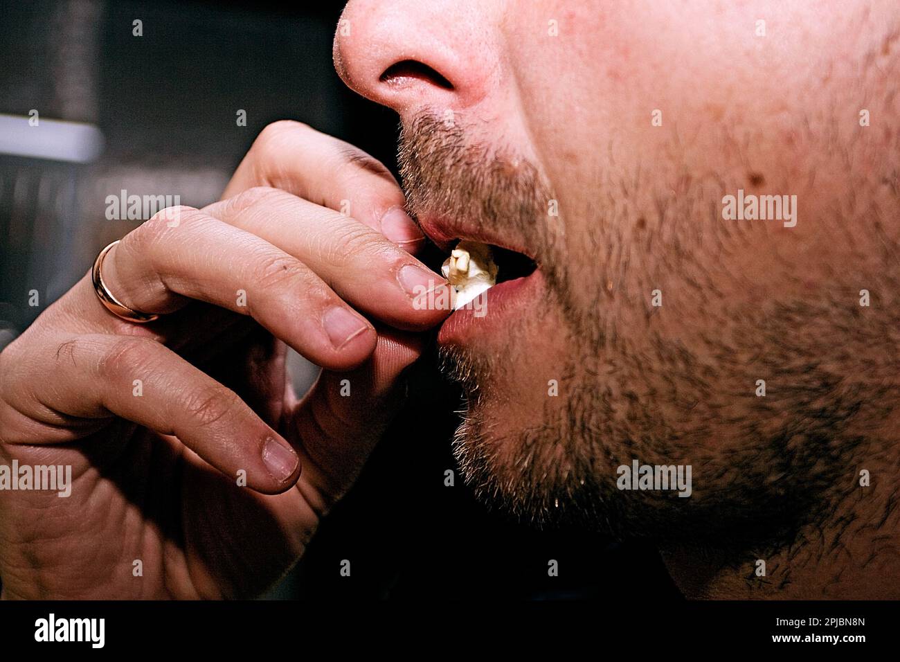 profile of a man eating popcorn Stock Photo - Alamy