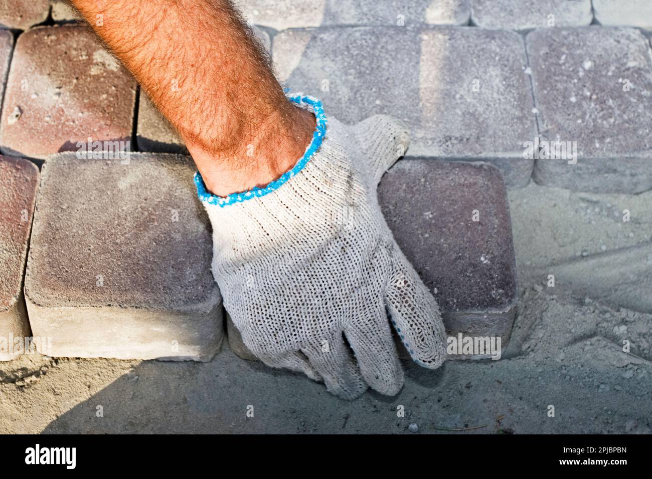 Construction worker fixing the pavestone on the roadtion worker ...