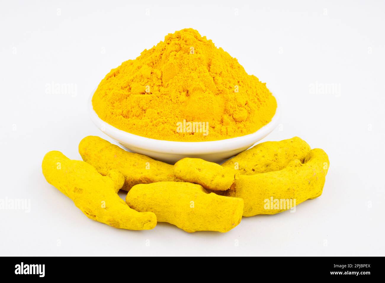 Raw turmeric with turmeric powder on white background Stock Photo - Alamy