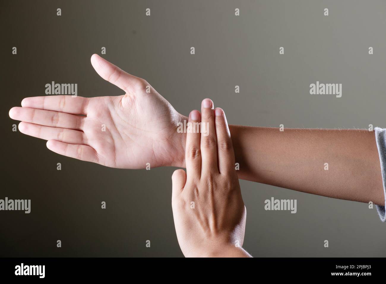 Female wrist self check pulse rate on grey background Stock Photo - Alamy