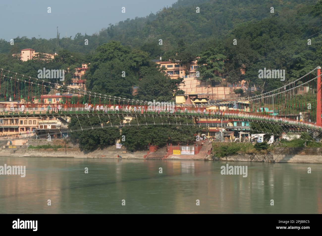Beautiful view of ram jhula with ganga river and mountains in rishikesh ...
