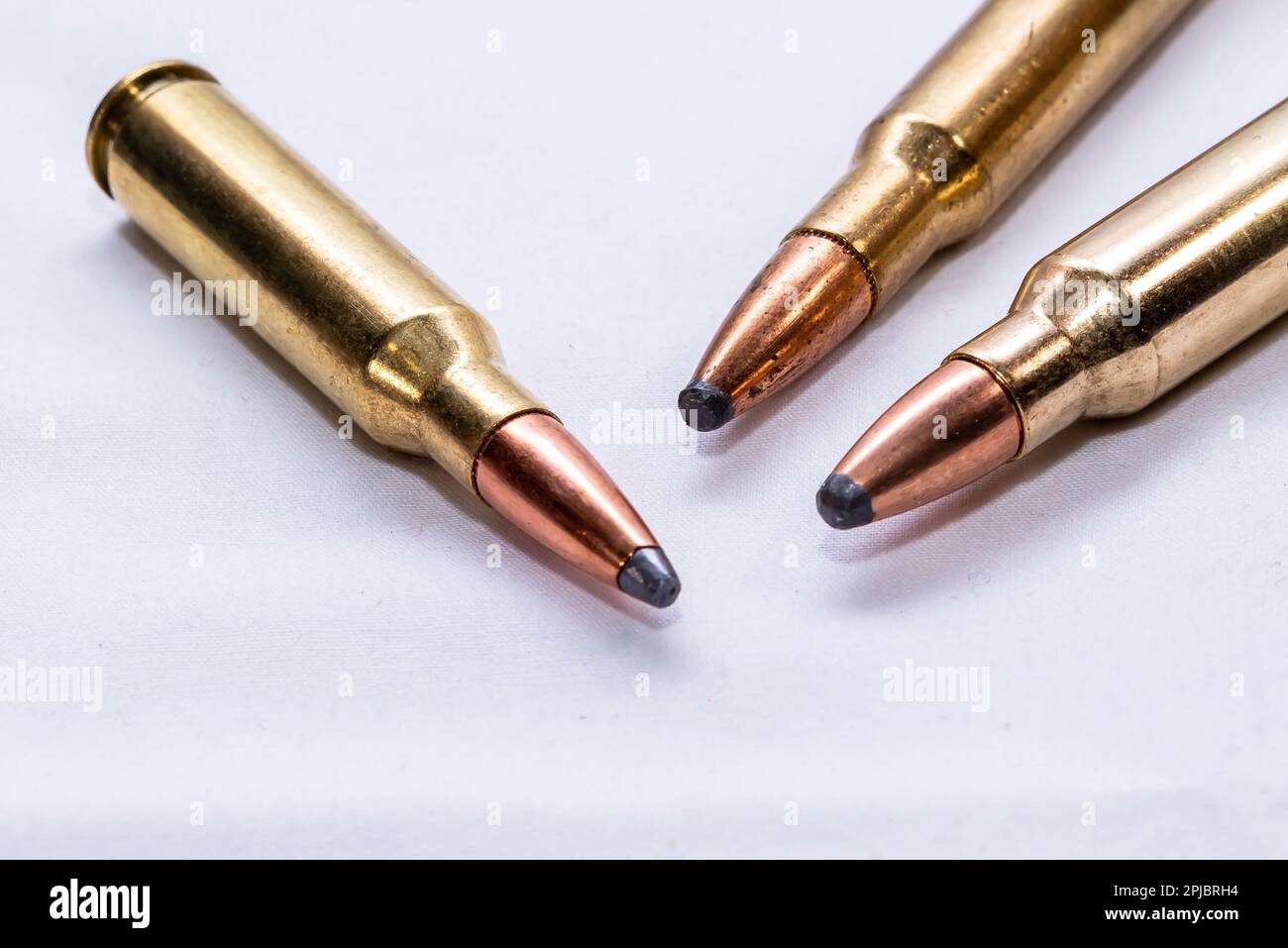 Three different caliber hunting rifle bullets on a white background ...