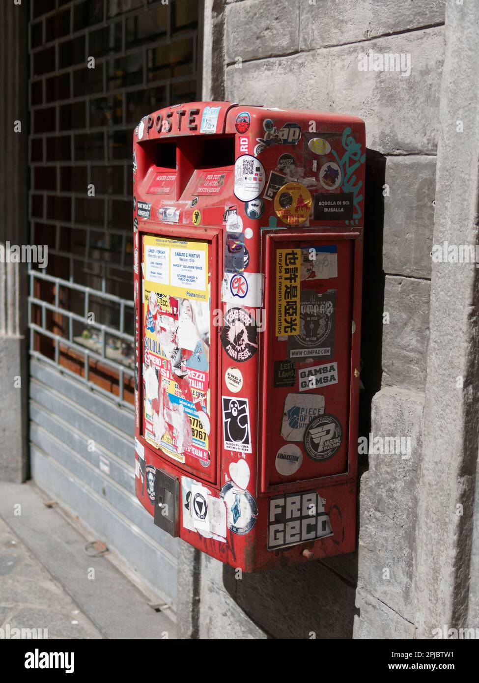 Old style red post box in Aosta covered in stickers. Aosta Valley ...