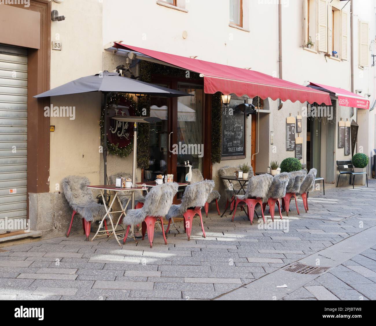 Fur covered seats outside a cafe/bar in the city of Aosta, Aosta Valley ...