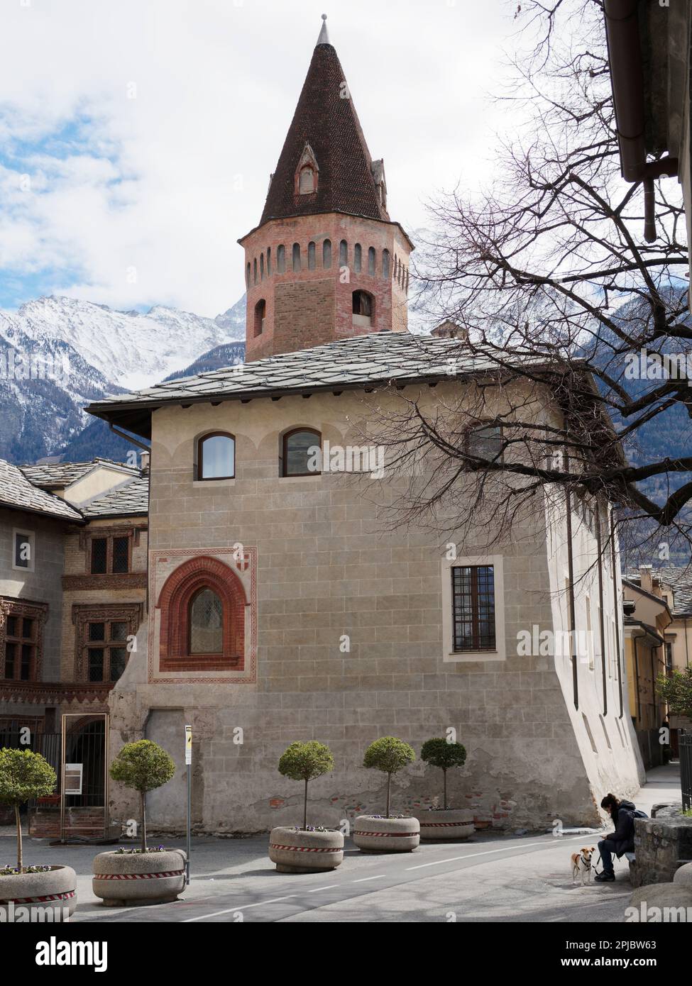 Unusual shaped building with rotunda tower in the city of Aosta, Aosta ...