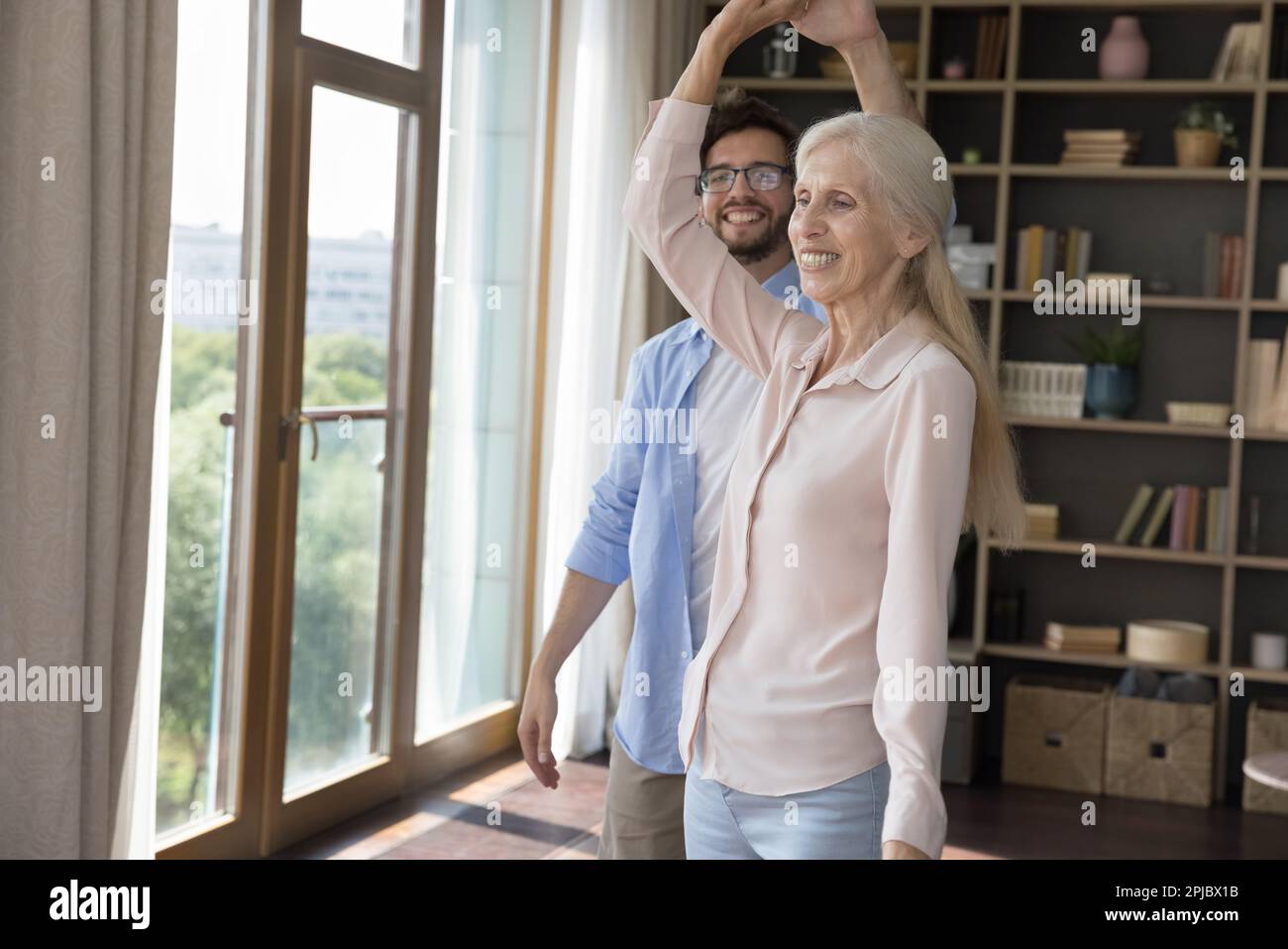 Positive teacher training happy senior lady to dance, teaching spinning ...