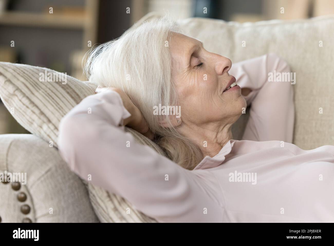 Relaxed sleepy older woman resting on comfortable couch Stock Photo - Alamy