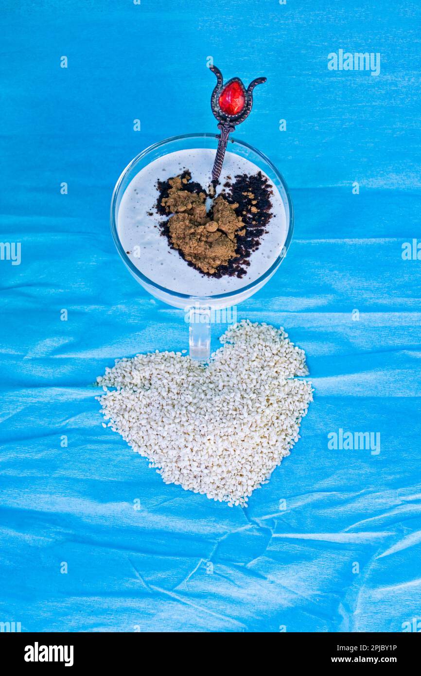 Sesame milk with a kerob on a blue background and ruby Stock Photo - Alamy
