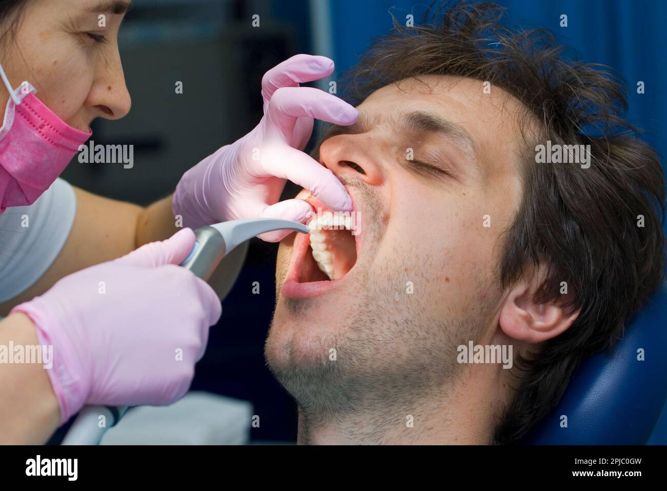 dentist grinds the front teeth to the patient Stock Photo - Alamy