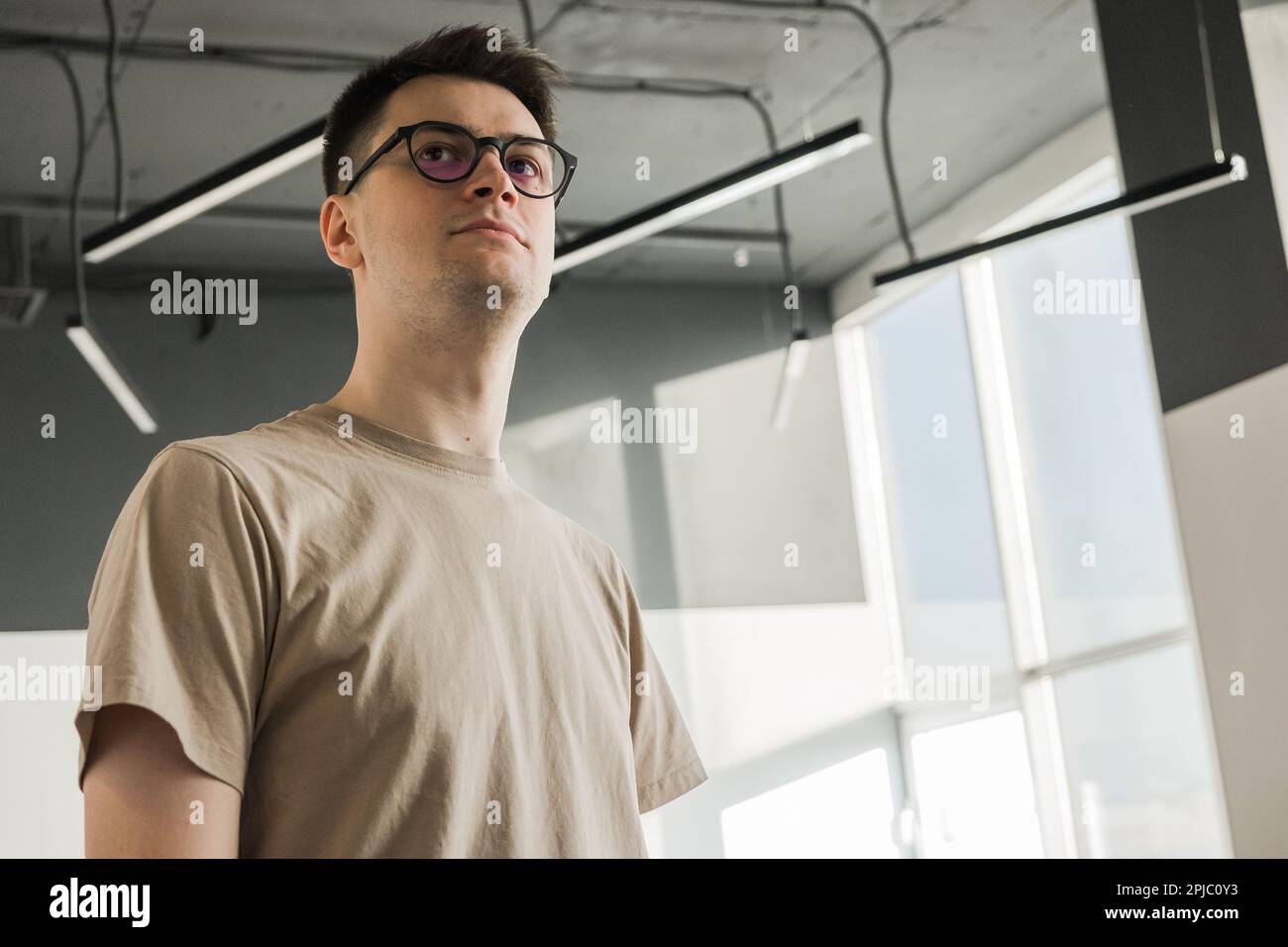 Portrait of a serious millennial male business owner in modern office ...