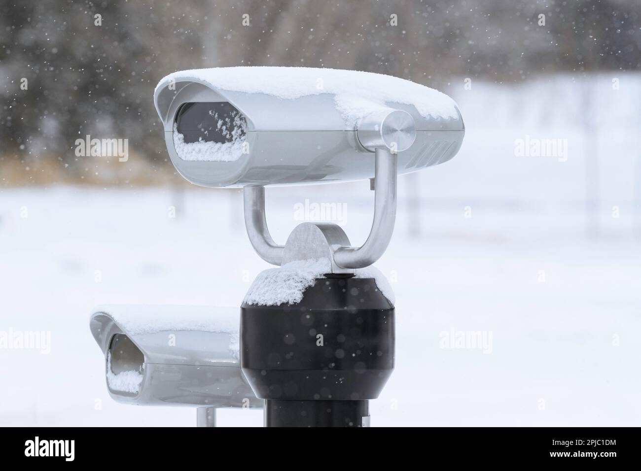 Stationary telescope or tower viewer during a light snowfall and low ...