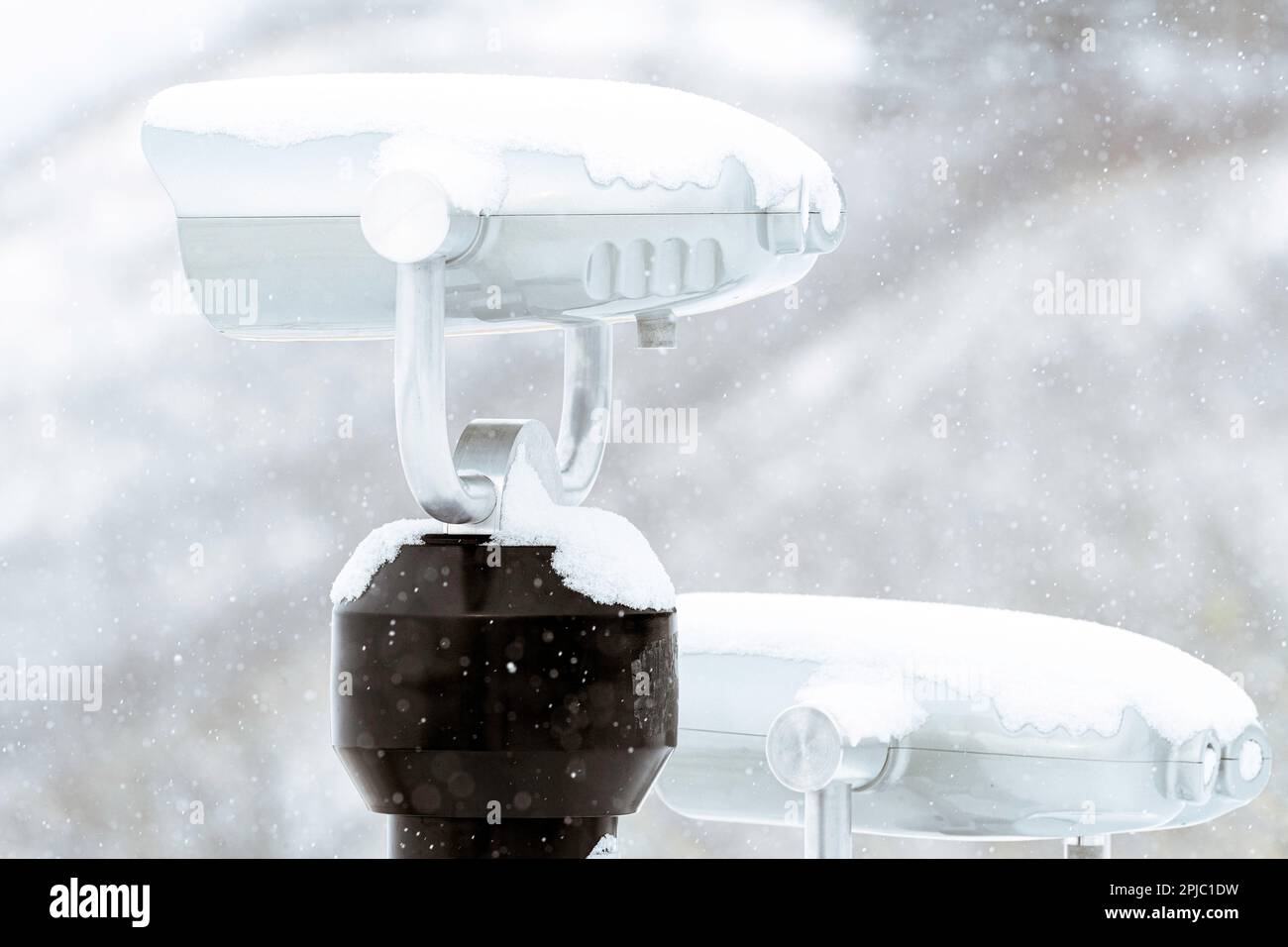 Stationary telescope or tower viewer during a light snowfall and low ...