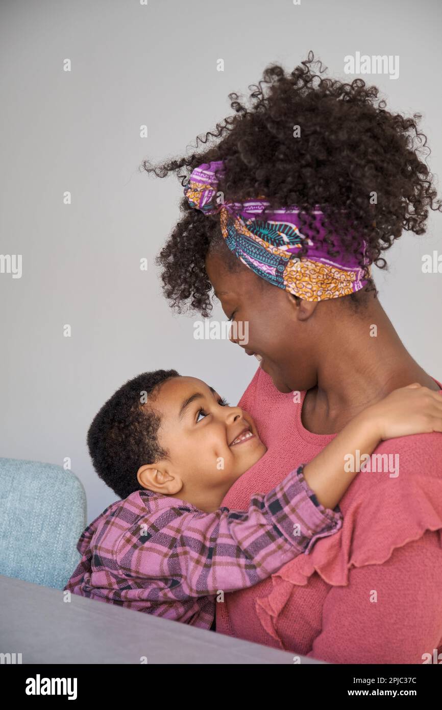 Smiling african mother and son hugging Stock Photo - Alamy