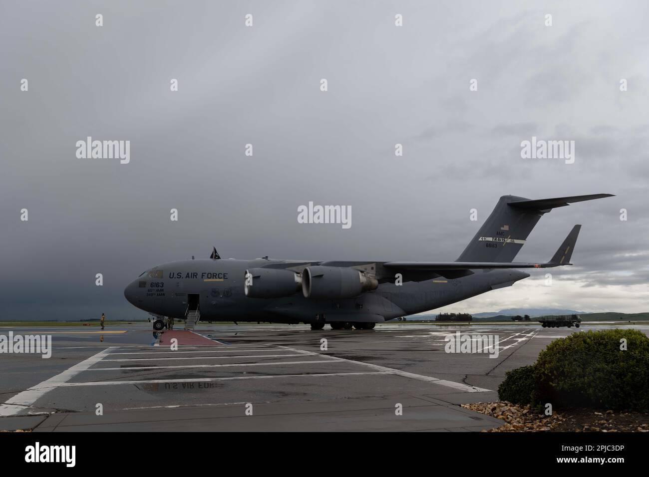 A U.S. Air Force C-17 Globemaster III parks at a commemorative landmark ...