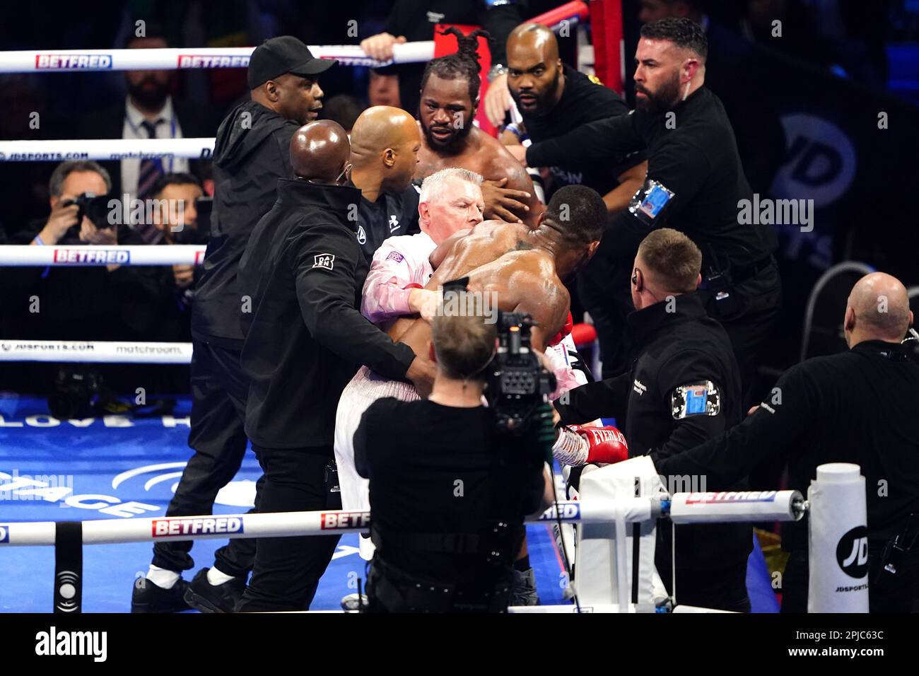 Anthony Joshua is pulled away by referee Marcus McDonnell after ...