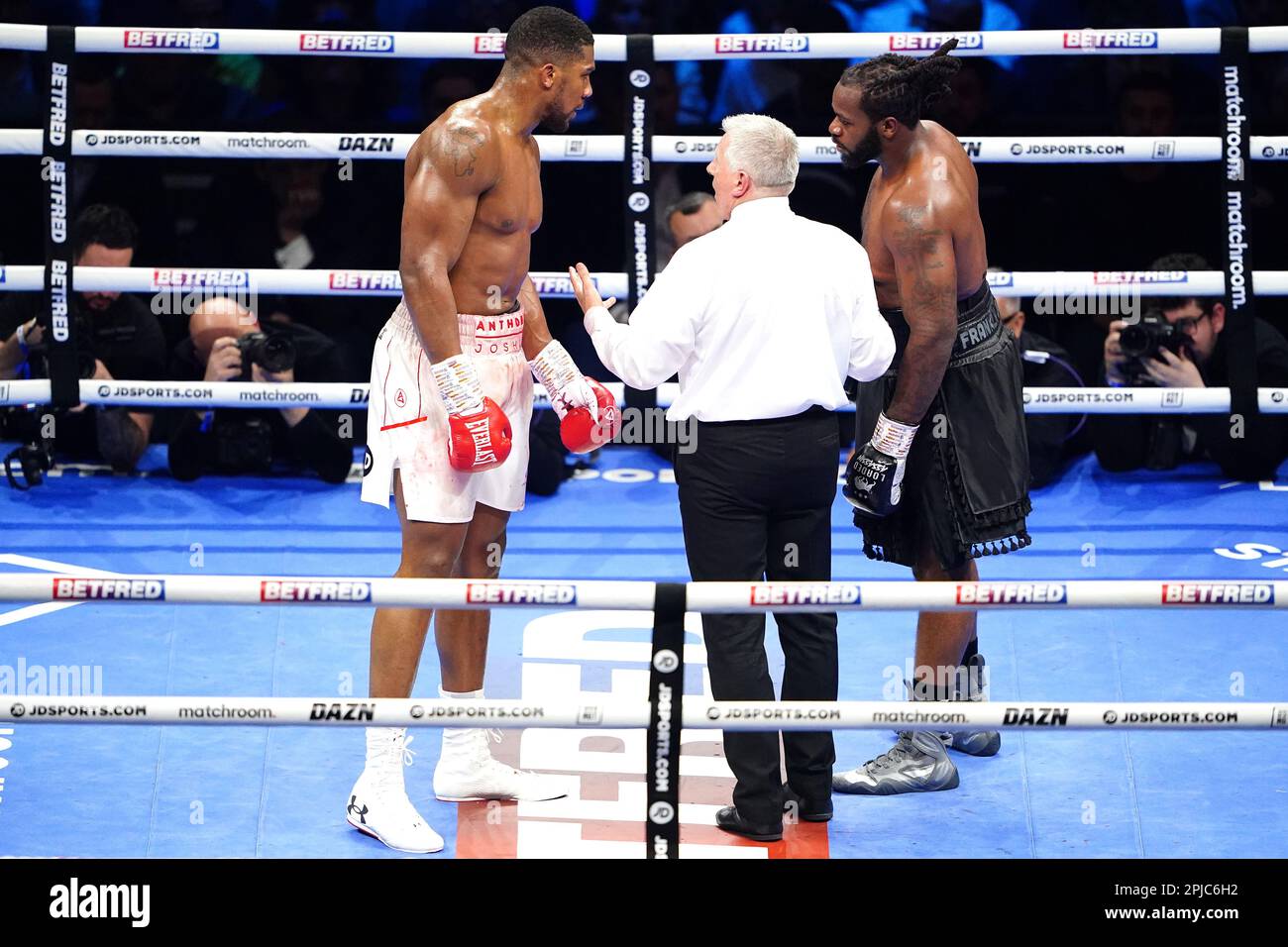 Referee Marcus McDonnell (centre) speaks to Anthony Joshua and Jermaine ...