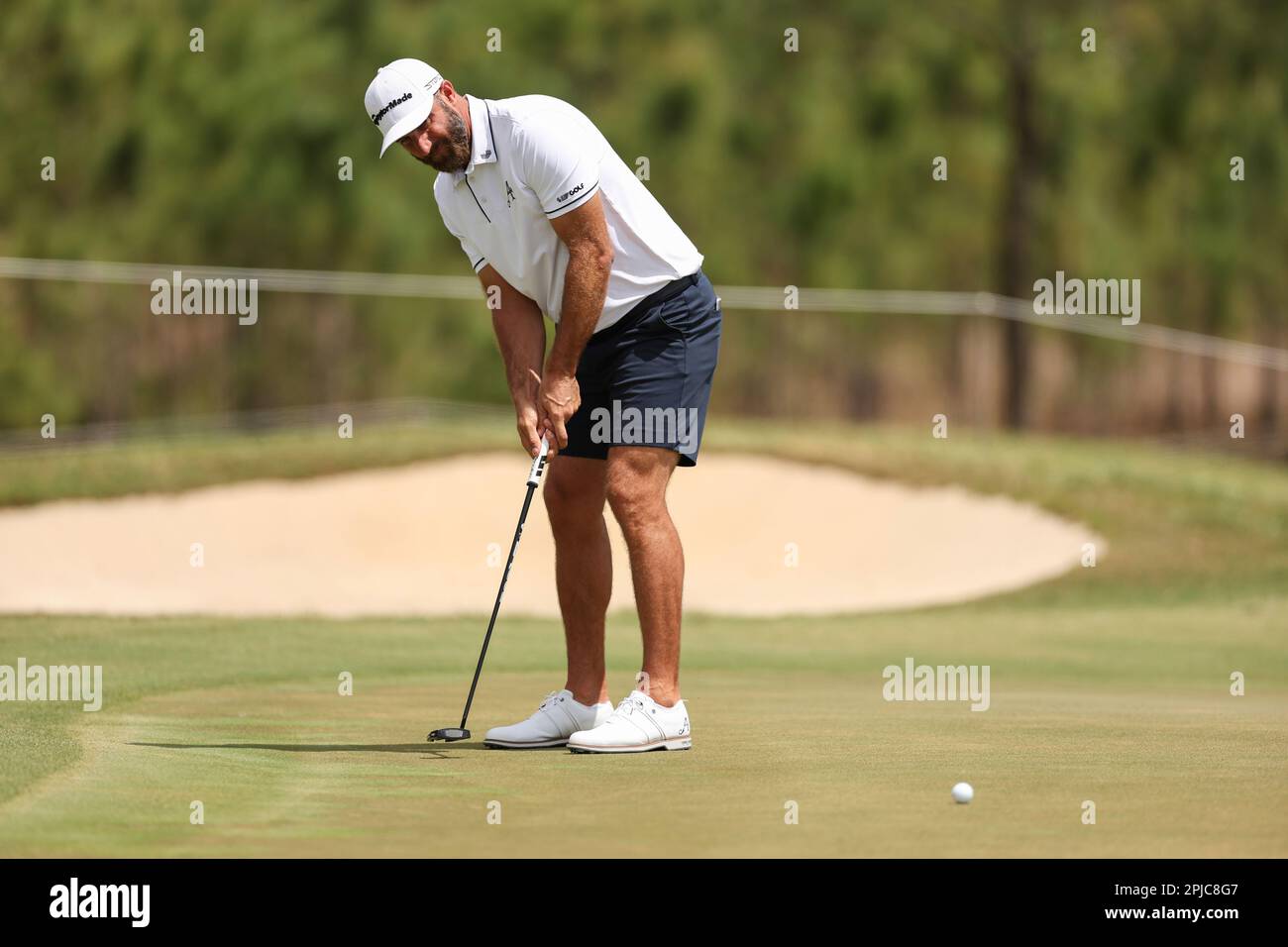Captain Dustin Johnson of 4Aces GC putts on the third green during the ...