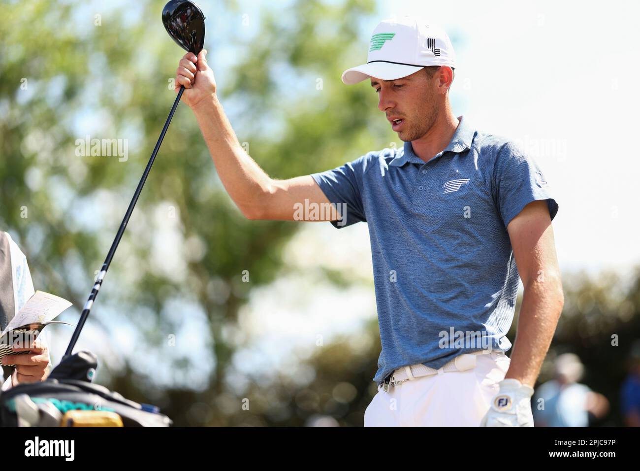 David Puig of Torque GC puts his golf club away on the second hole ...